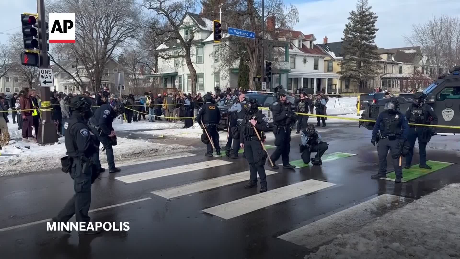 A large throng of protesters gathered at the scene after the shooting ...