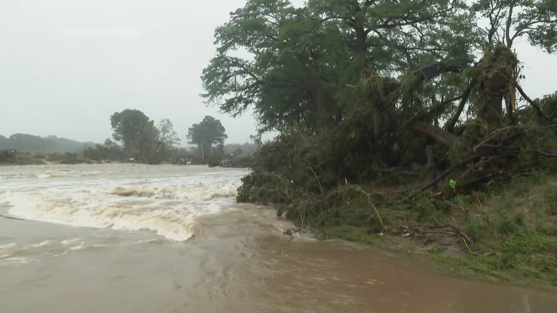 Fast moving flood waters from Guadalupe River rush over road in Texas ...